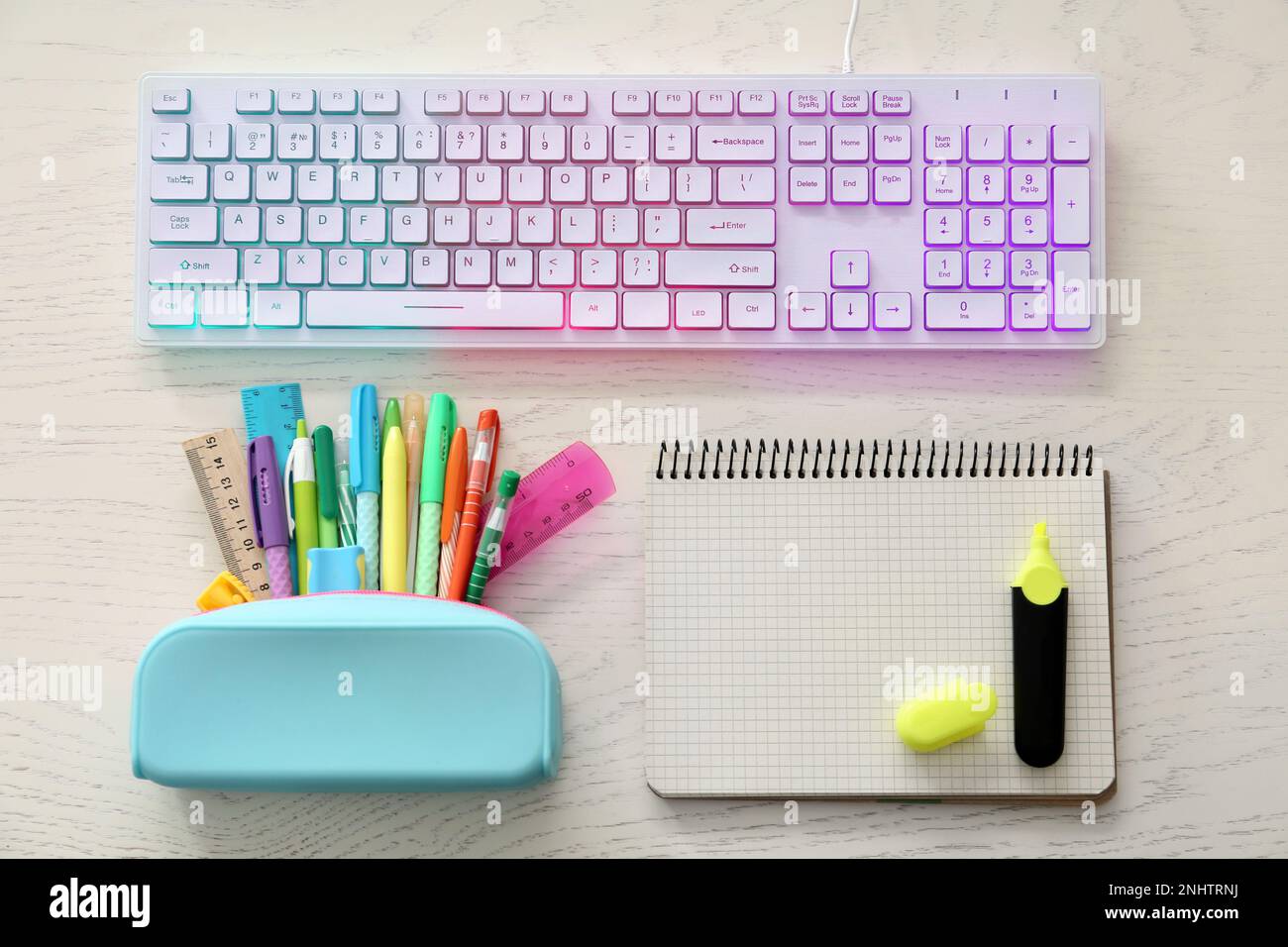 Flat lay composition with modern RGB keyboard on white wooden table ...