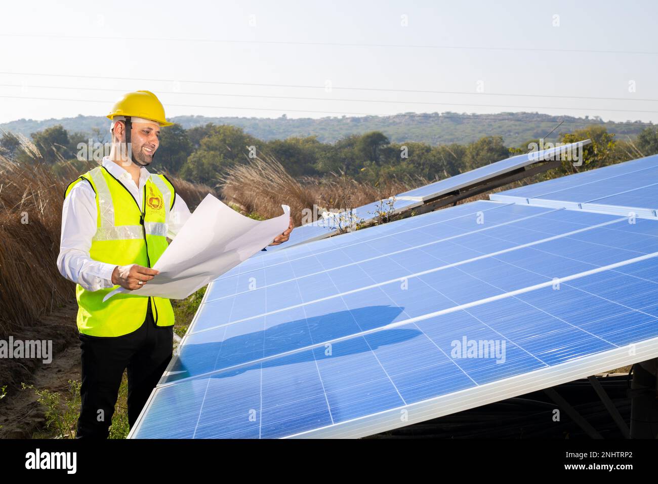Portrait of Young indian man technician wearing yellow hard hat ...