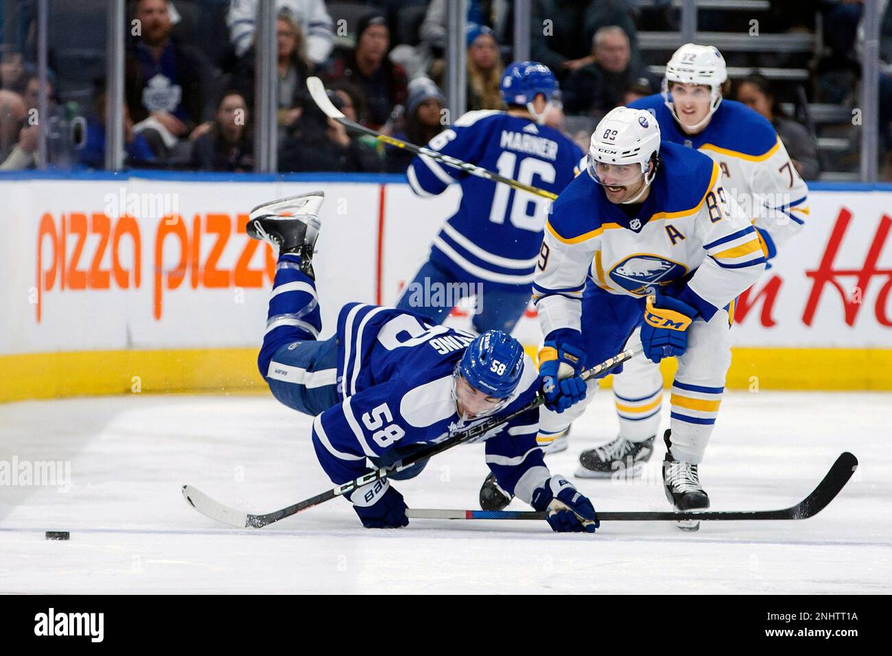 Toronto Maple Leafs' Michael Bunting (58) falls to the ice as Buffalo ...