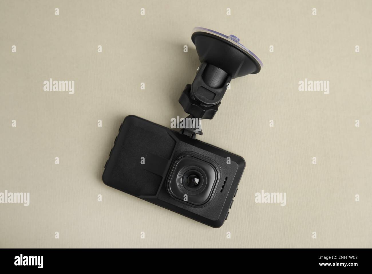 Modern car dashboard camera with suction mount on light background, top ...