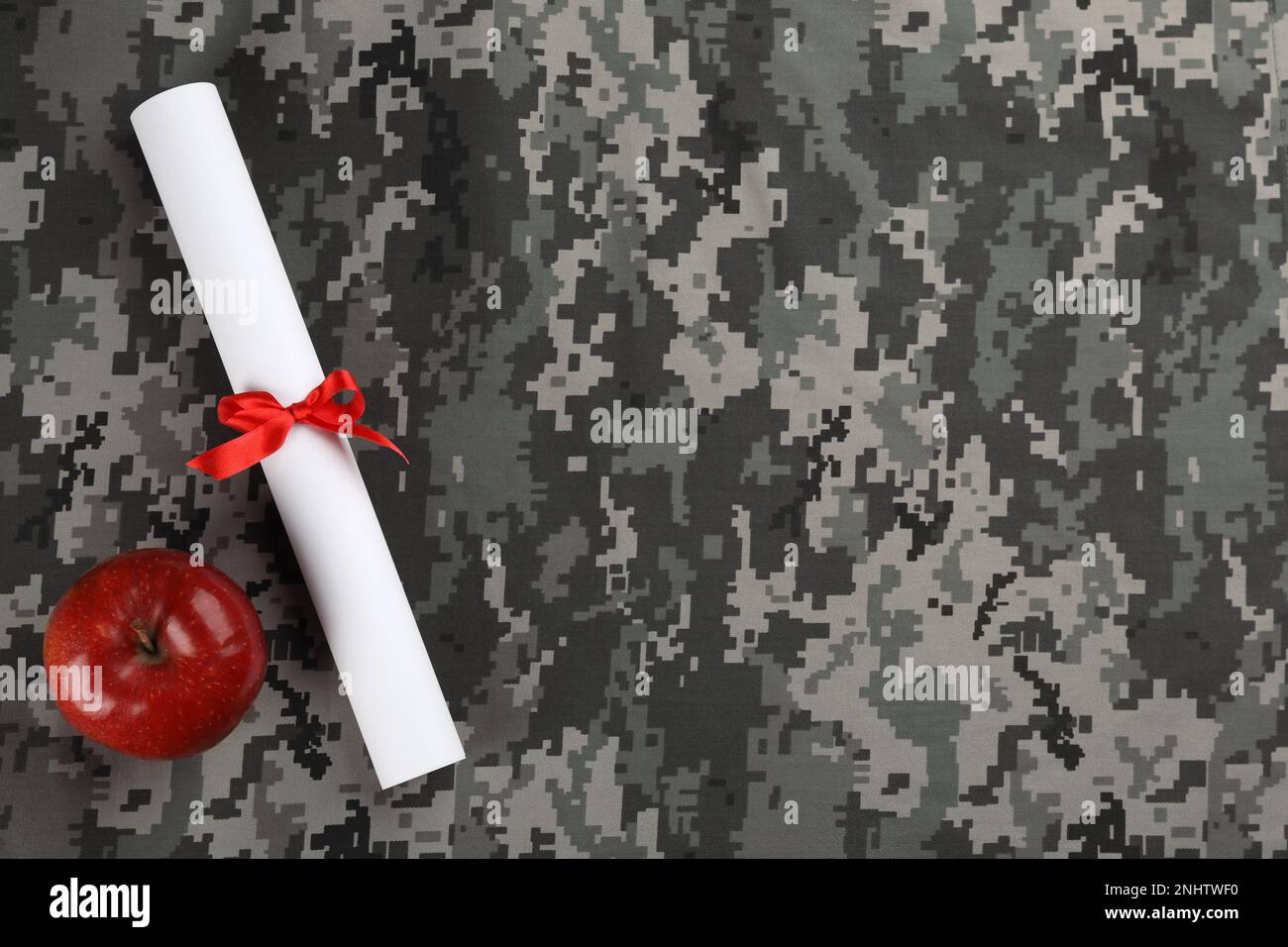 Apple and diploma on camouflage background, flat lay with space for ...
