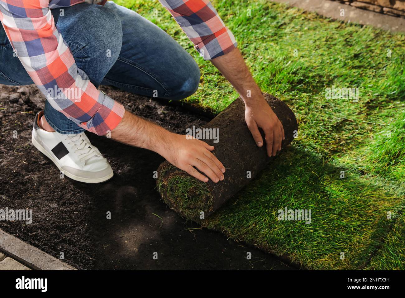 Man laying on grass hands hi-res stock photography and images - Alamy