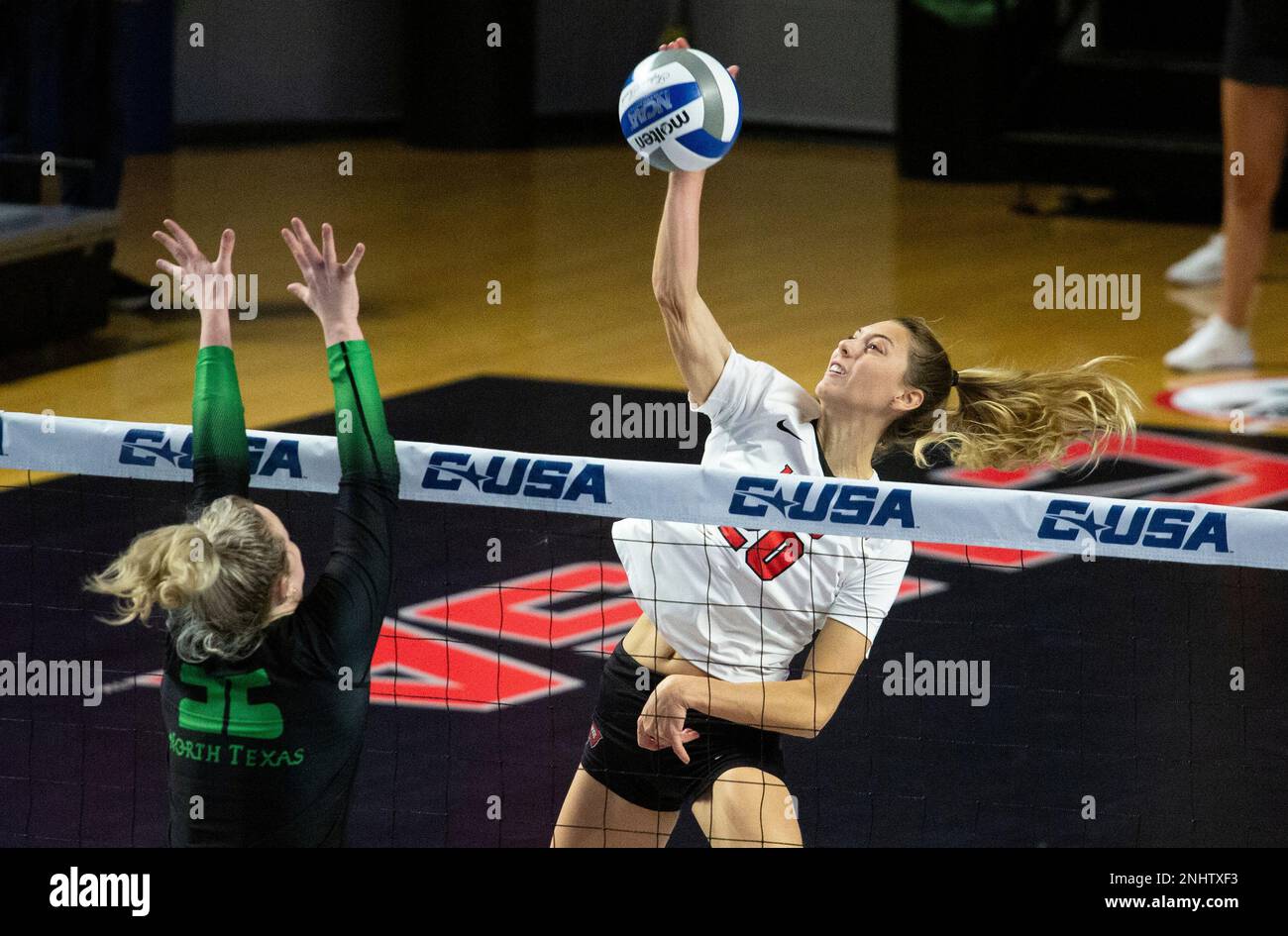 Western Kentucky's Katie Isenbarger (20) spikes the ball past North ...