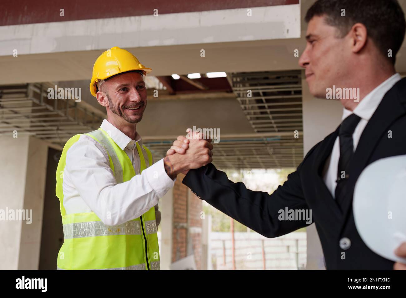 Civil Construction team Handshake at renovate construction site ...