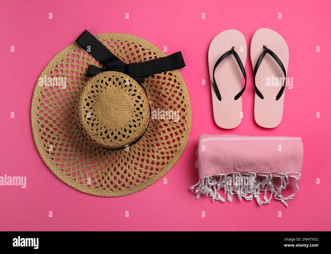 Hat, flip flops and blanket on pink background, flat lay. Beach object ...