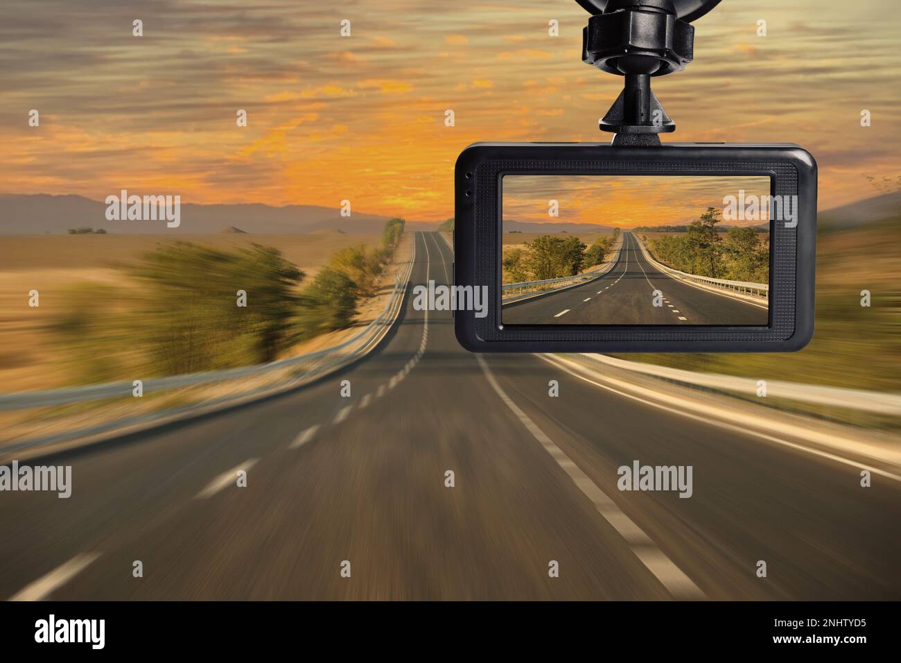 Modern dashboard camera mounted in car, view of road during driving ...
