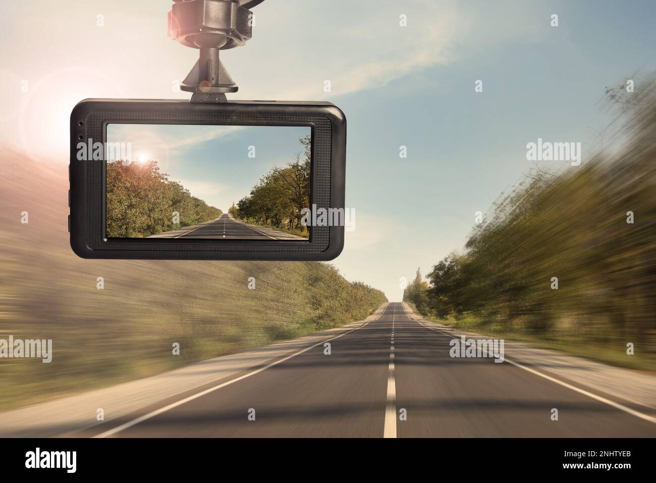 Modern dashboard camera mounted in car, view of road during driving ...