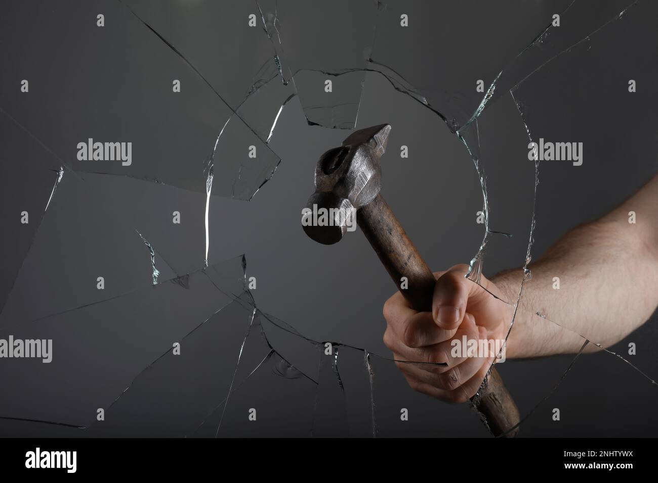 Man breaking window with hammer on grey background, closeup Stock Photo ...