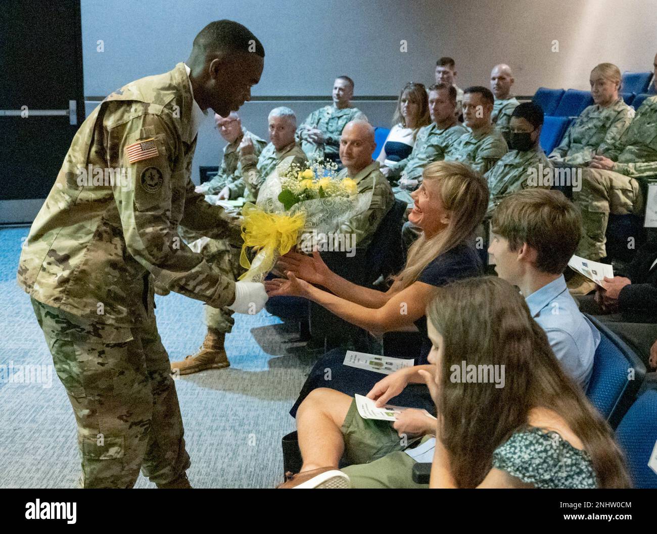 Jackie Edwards receives a bouquet of yellow roses during her husband’s ...