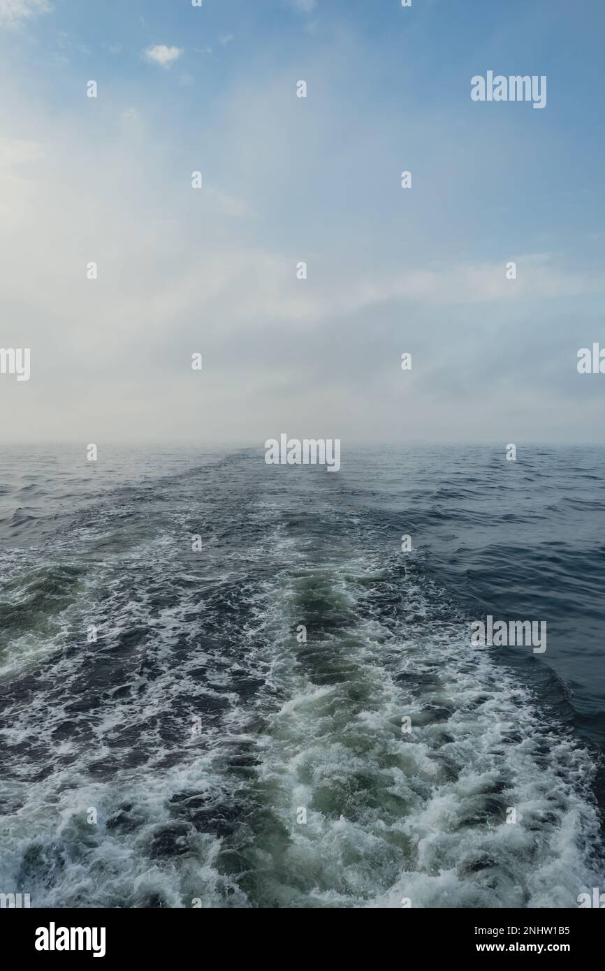 Wake of vessel. Wide wake trail from boat. Ocean water. Deep blue ...