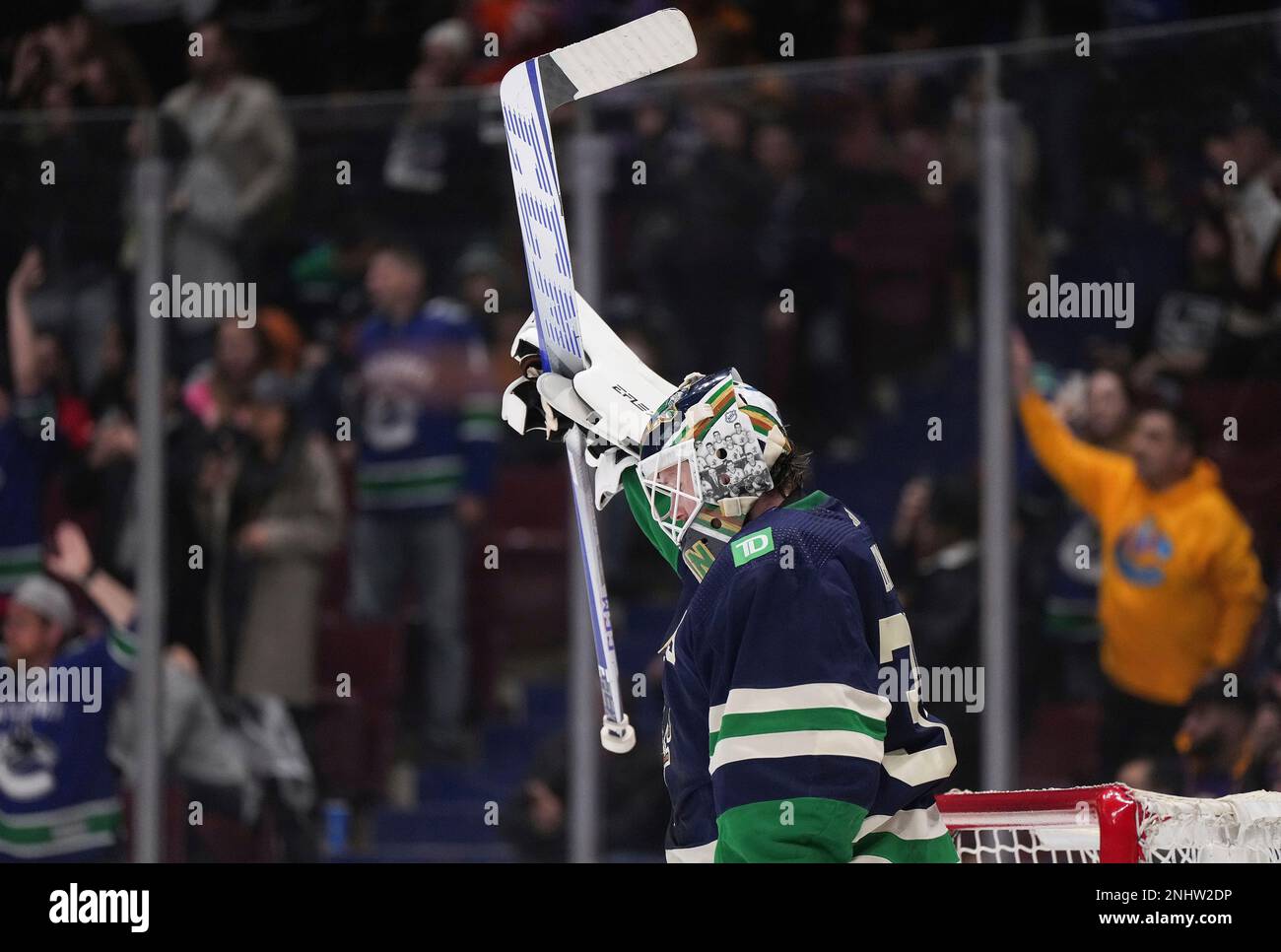 Vancouver Canucks goalie Thatcher Demko raises his stick after the team ...