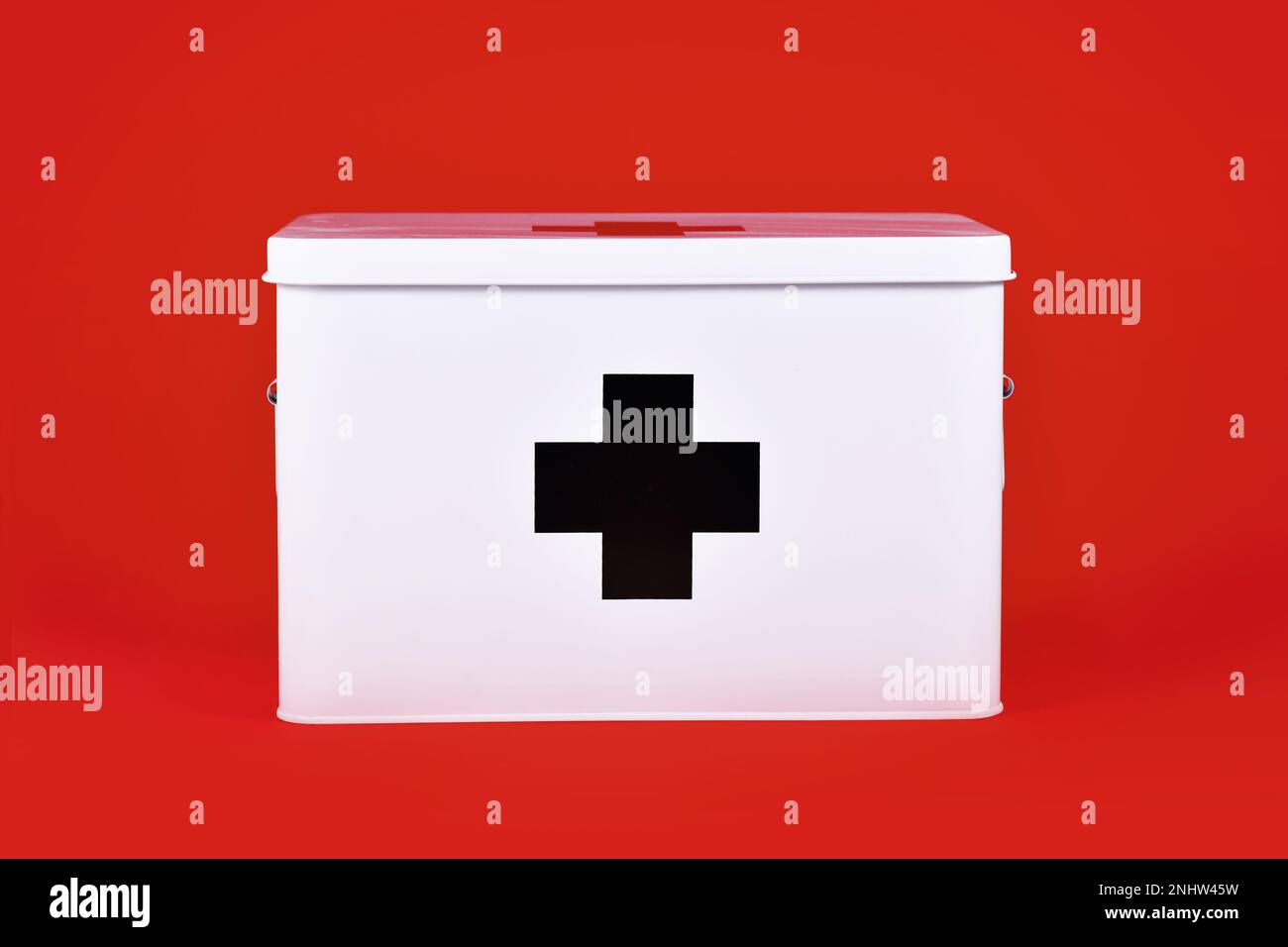 White first aid kit with black cross on red background Stock Photo - Alamy