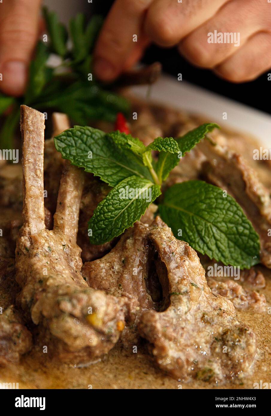 Chef Massimo Conti of La Ciccia restaurant prepares lamb stew at his ...