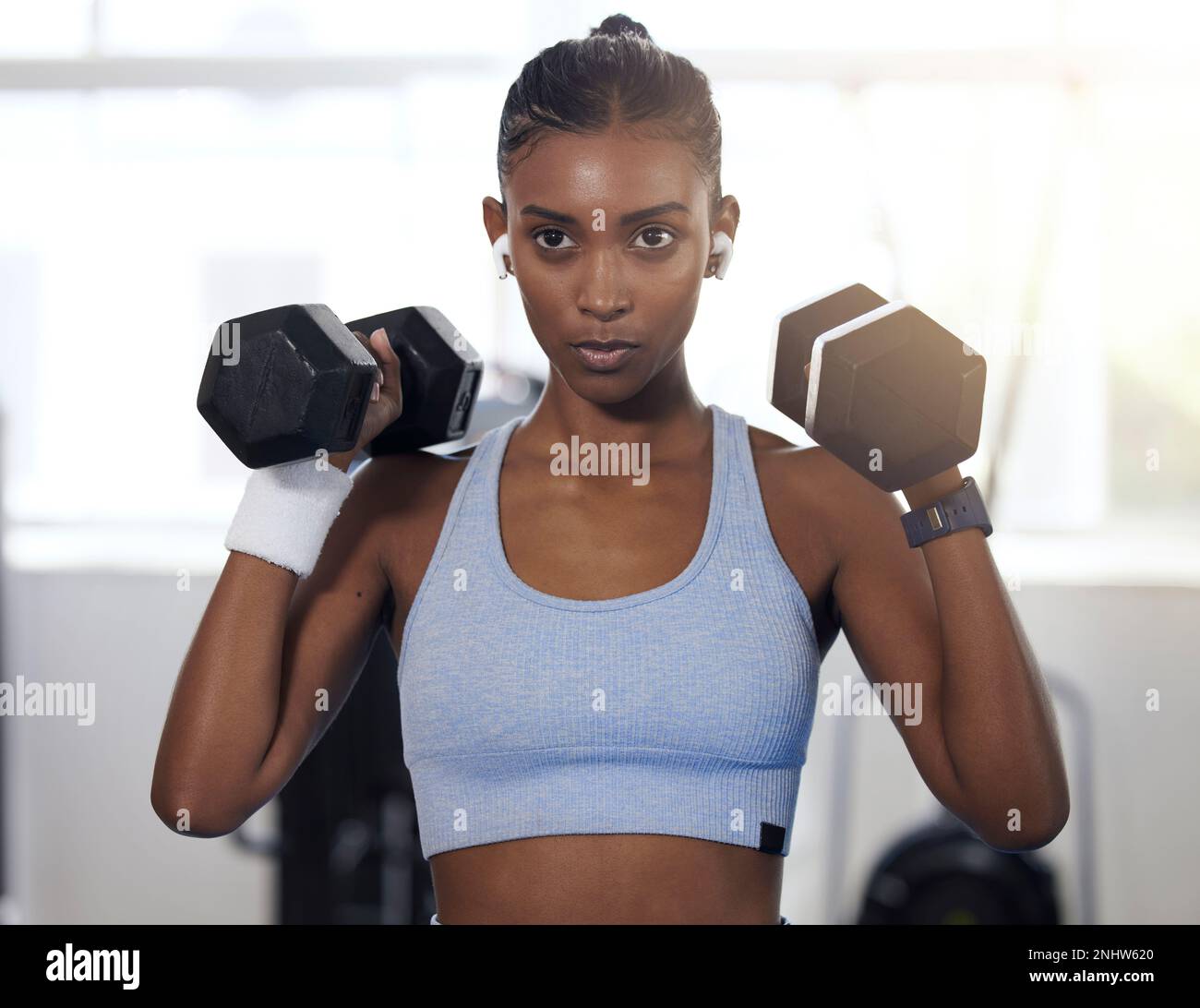 Woman, fitness and weightlifting dumbbells at gym for intense exercise ...