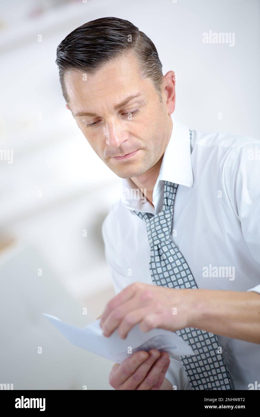 Surprised man reading documents hi-res stock photography and images - Alamy