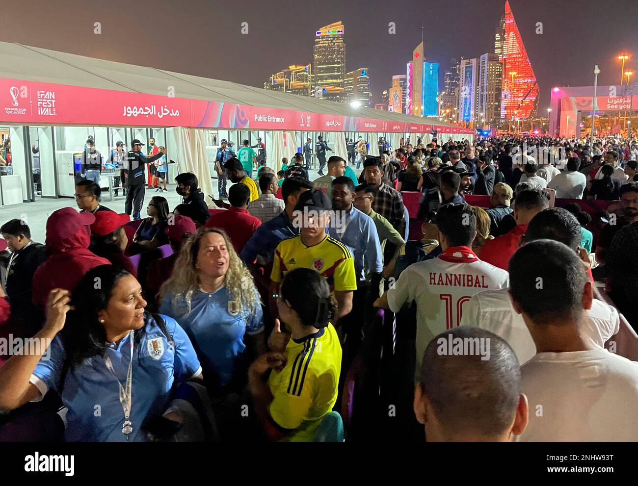 Football fans get excited during a test event of a fan zone in Doha ...