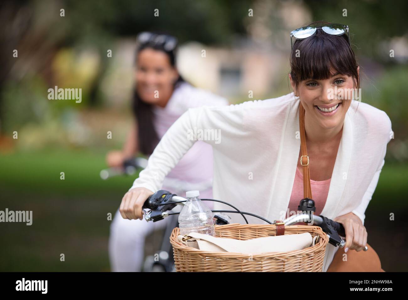 Two girls ride bicycle hi-res stock photography and images - Alamy
