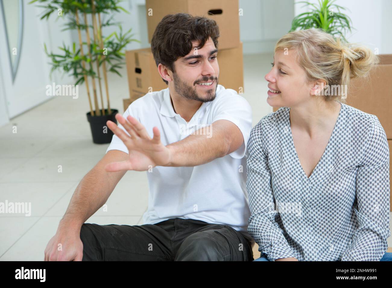 couple moving in house sitting on the floor while talking Stock Photo ...