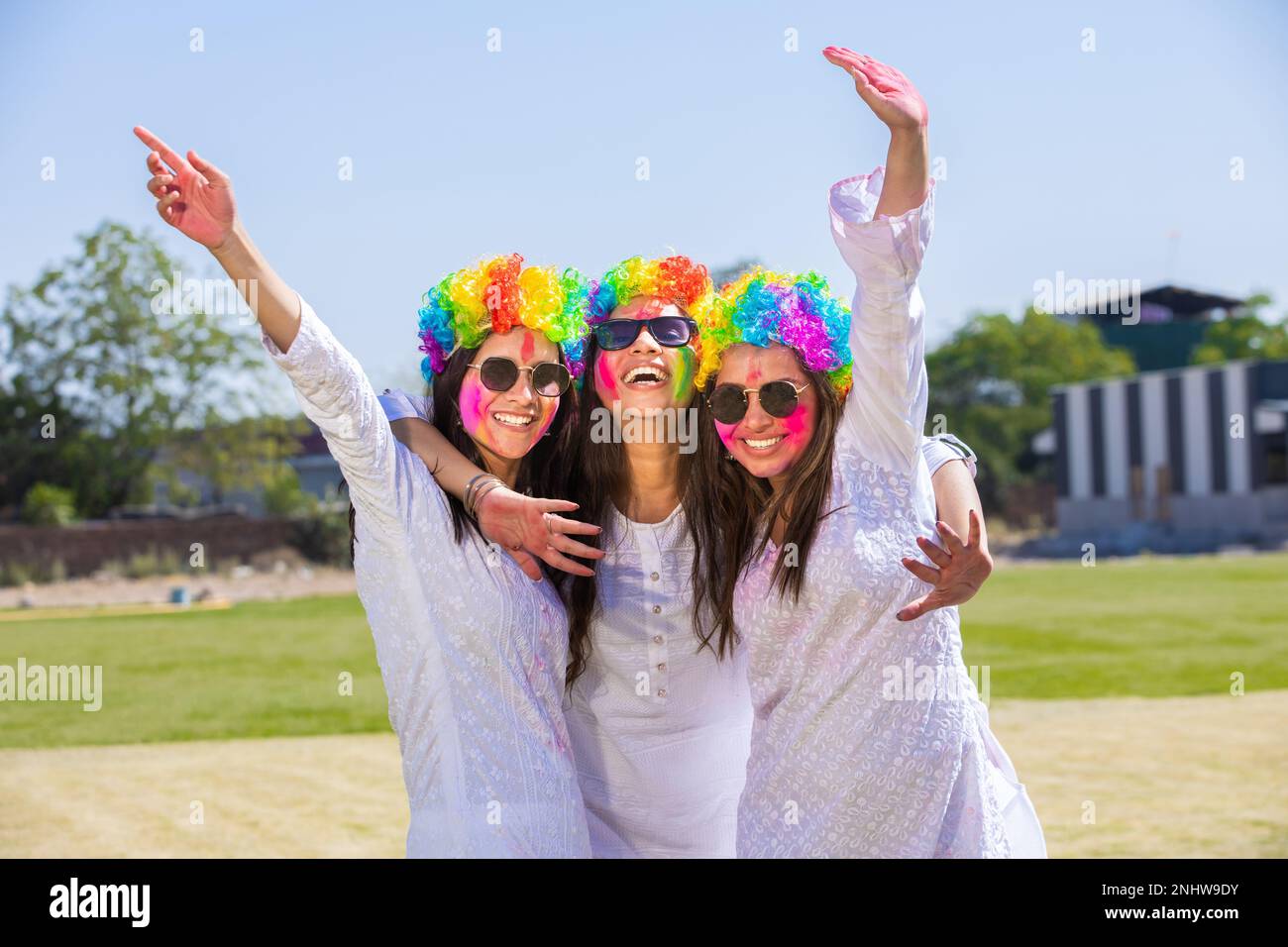 Group of cheerful young indian friends wearing white kurta and colorful ...