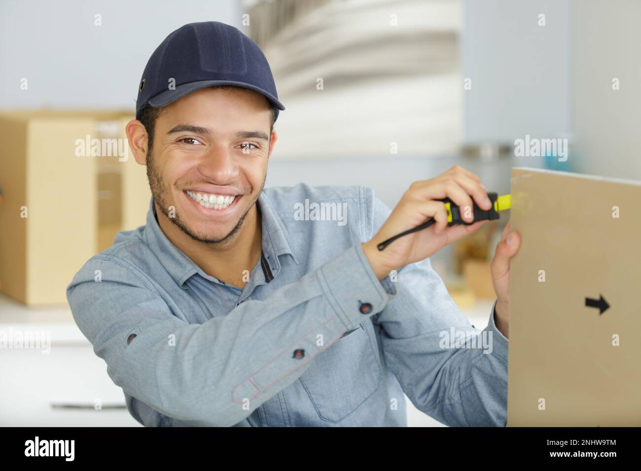 happy man during drawer installation Stock Photo - Alamy
