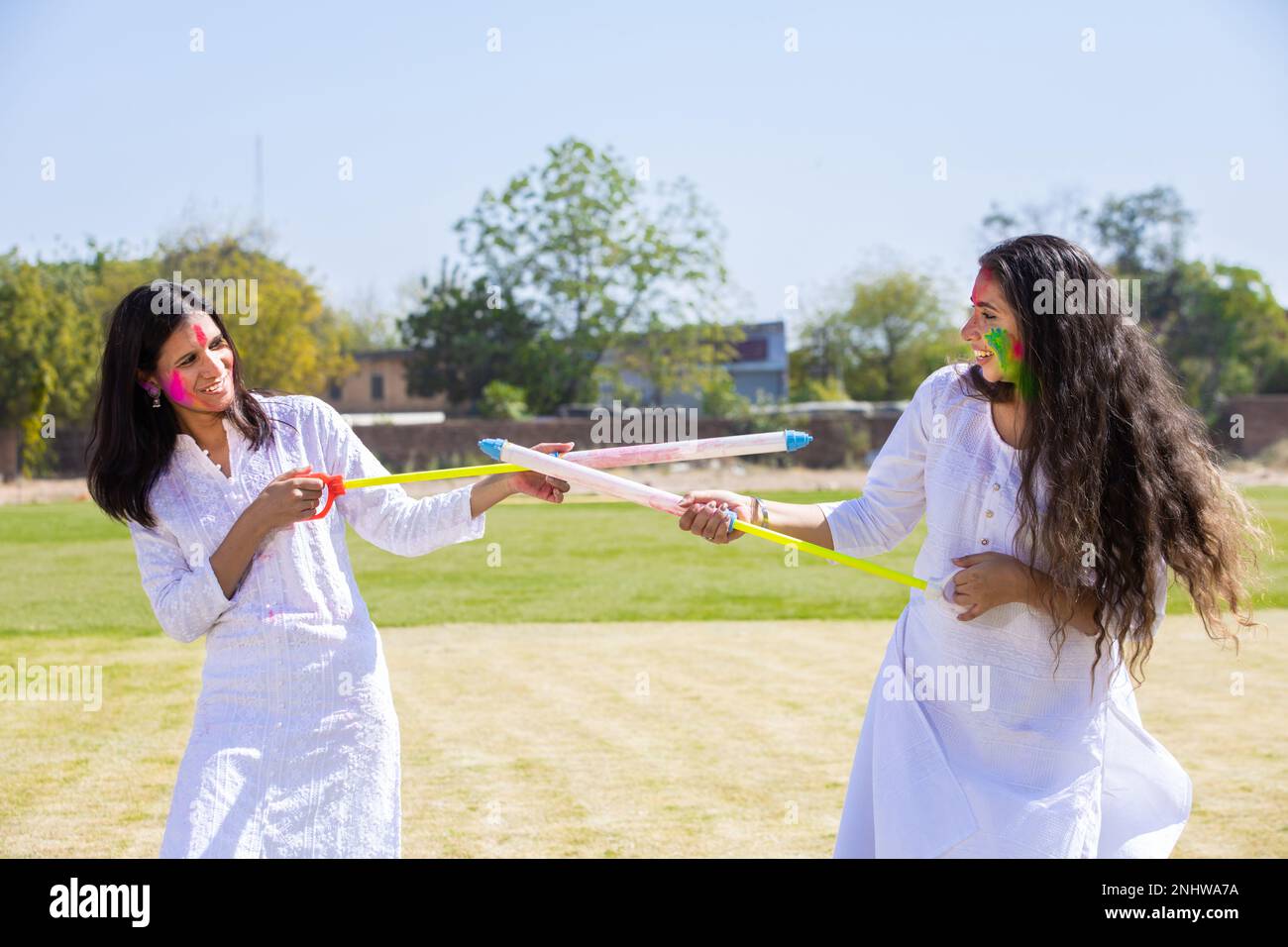 Two indian girls playing holi hi-res stock photography and images - Alamy
