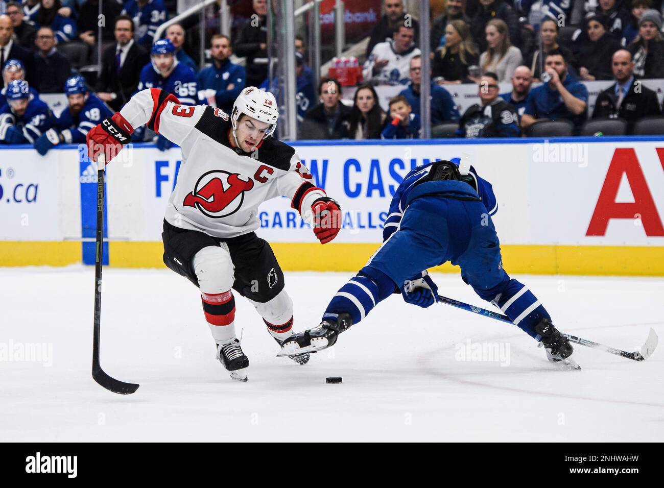 New Jersey Devils center Nico Hischier (13) maneuvers around Toronto ...