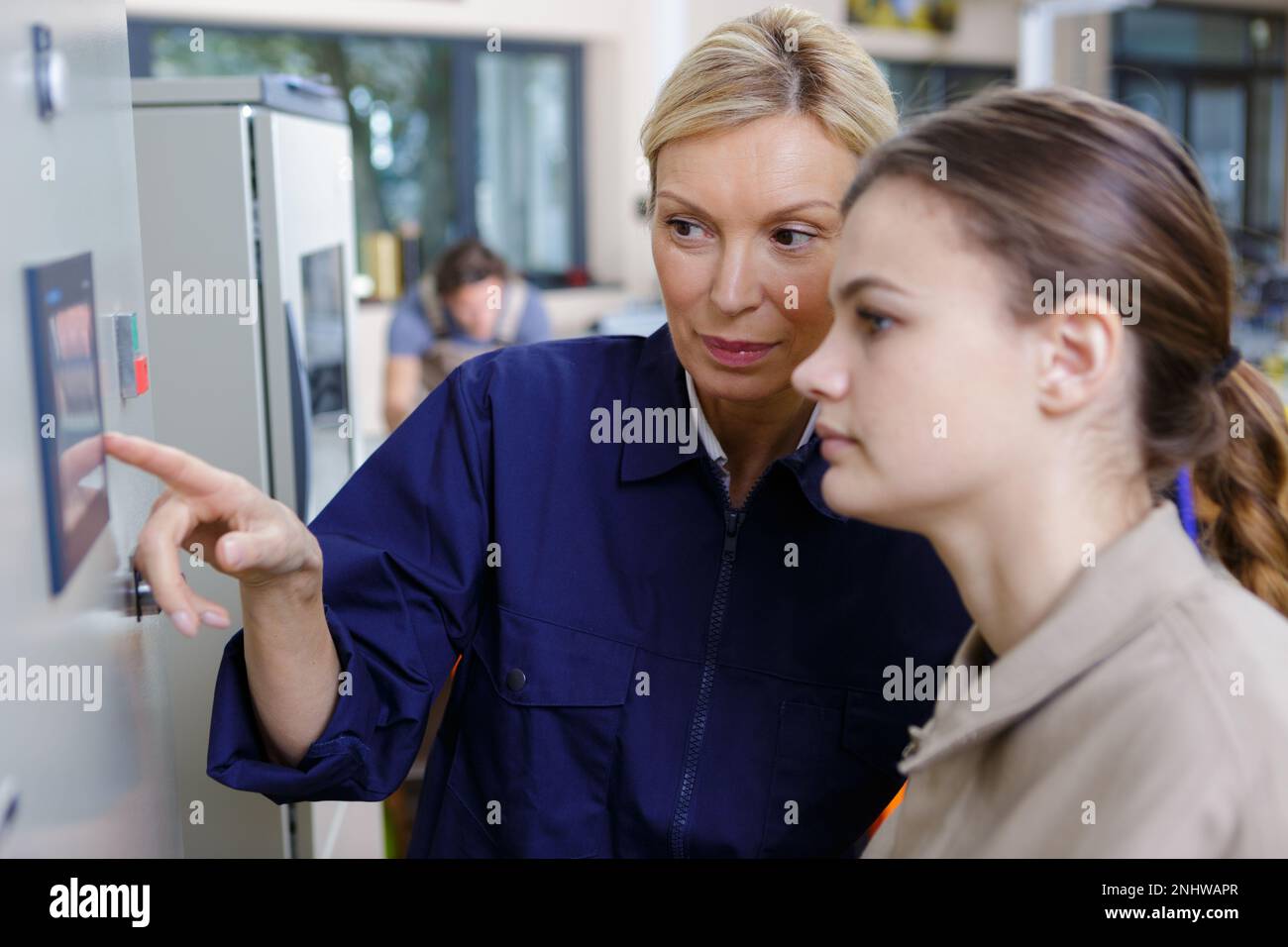 female apprentice operating a machine Stock Photo - Alamy