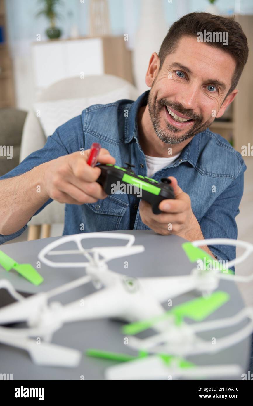 man attempting to fly drone indoor Stock Photo - Alamy