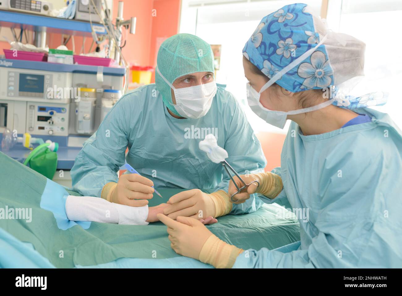 surgeon operating on patients hand assistant holding swab Stock Photo ...