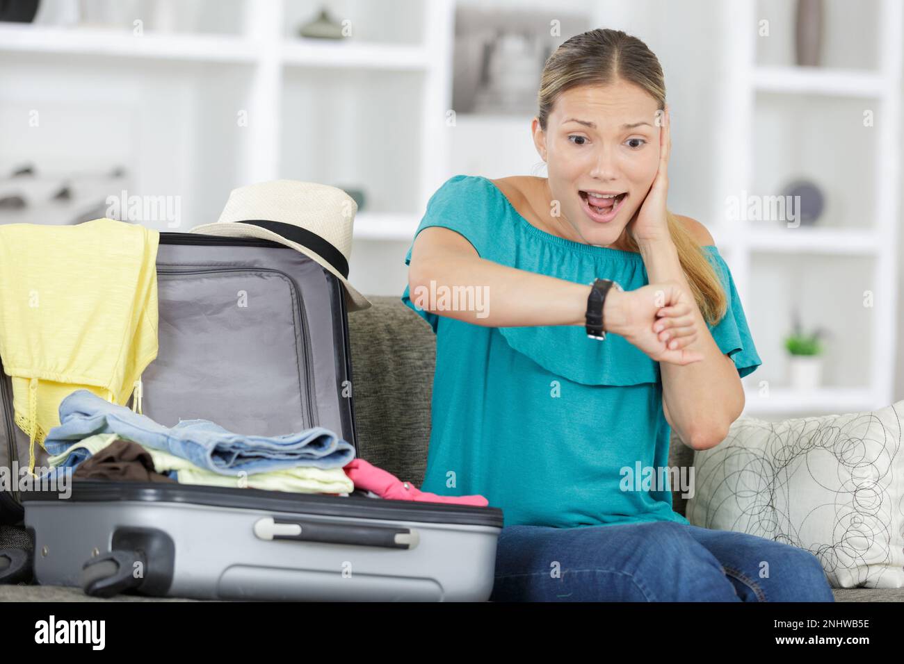 surprised woman late for flight Stock Photo - Alamy