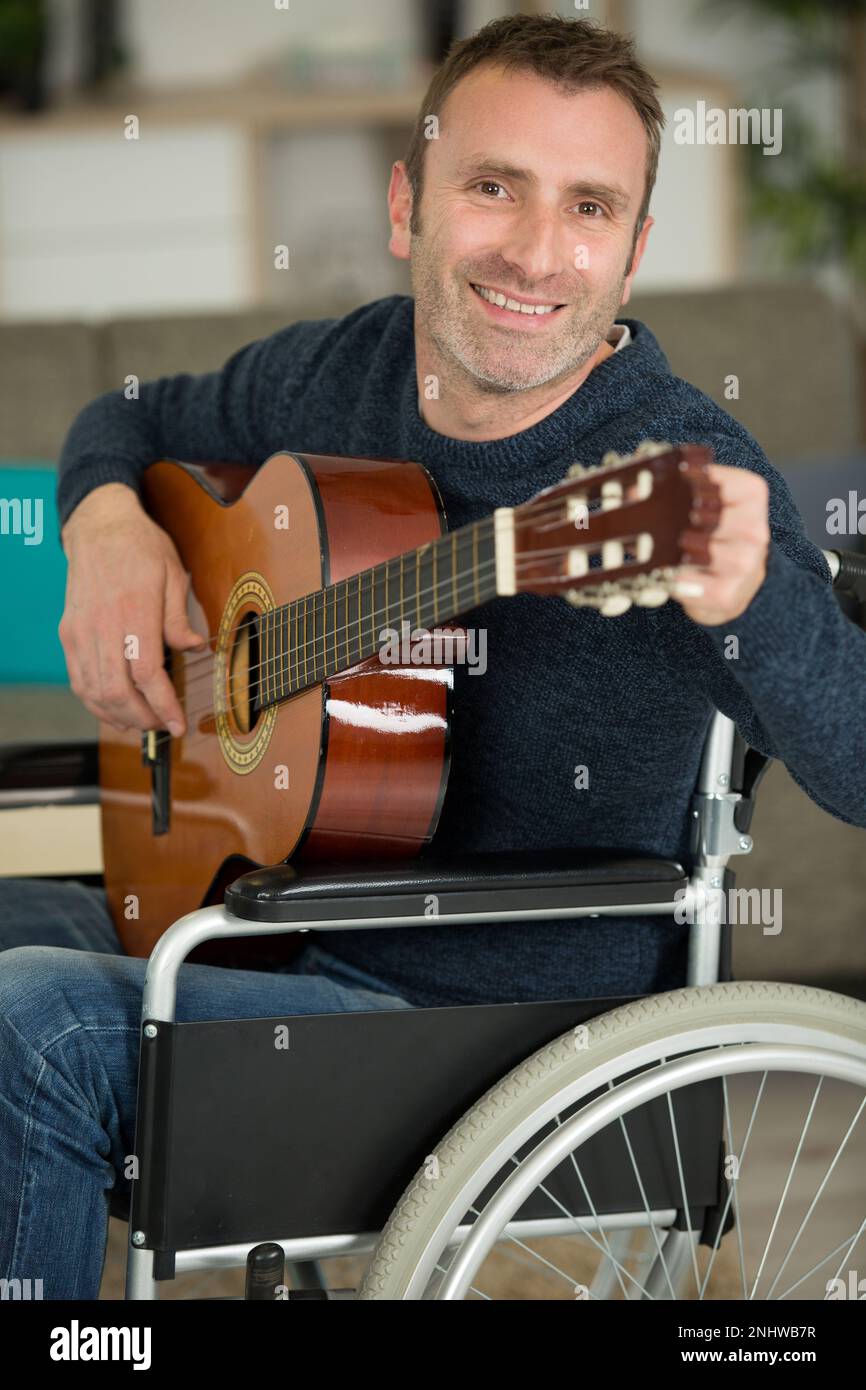 happy disable man playing guitar Stock Photo - Alamy