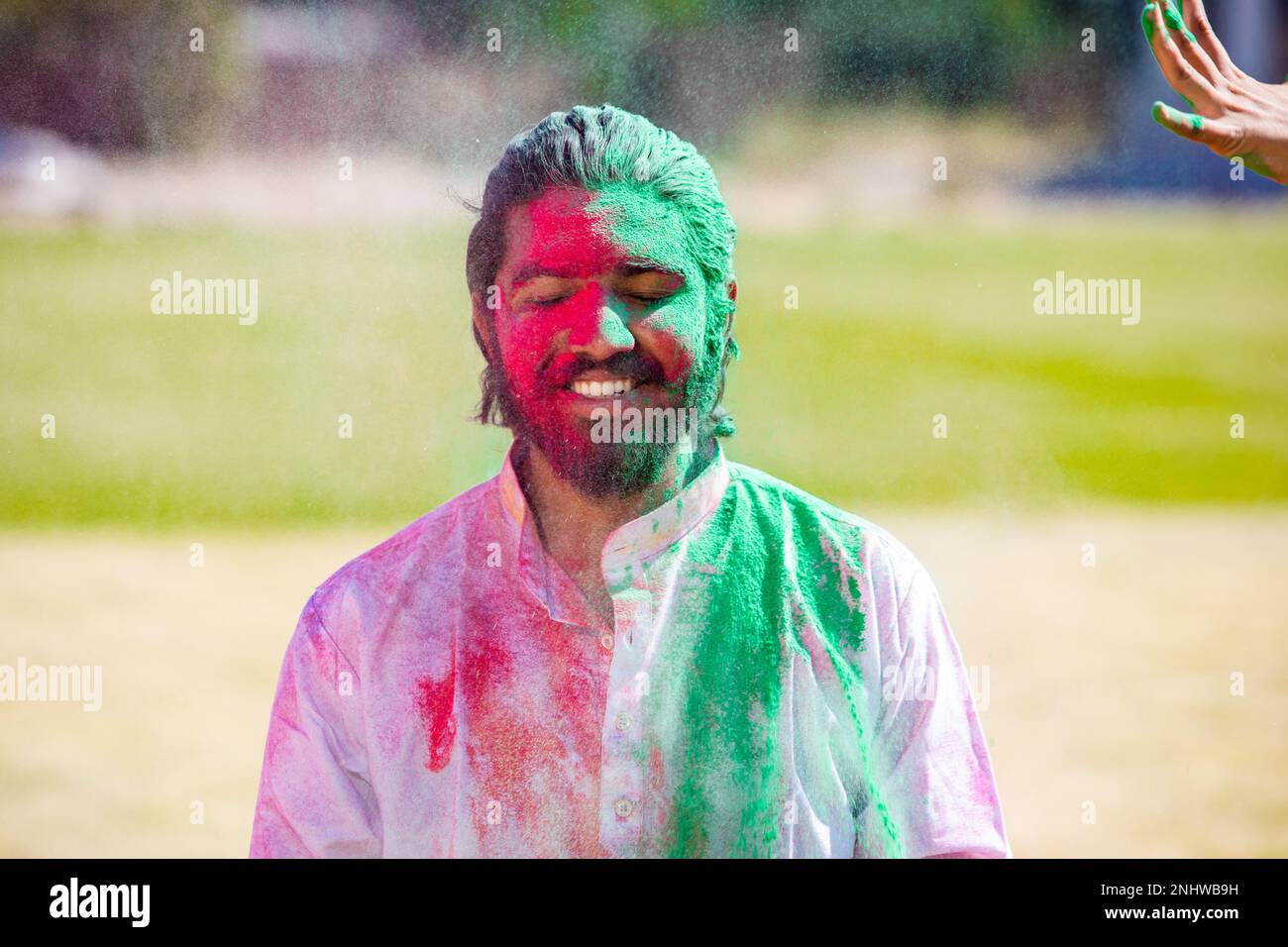 Portrait of happy Indian man wearing sunglasses and painted face ...