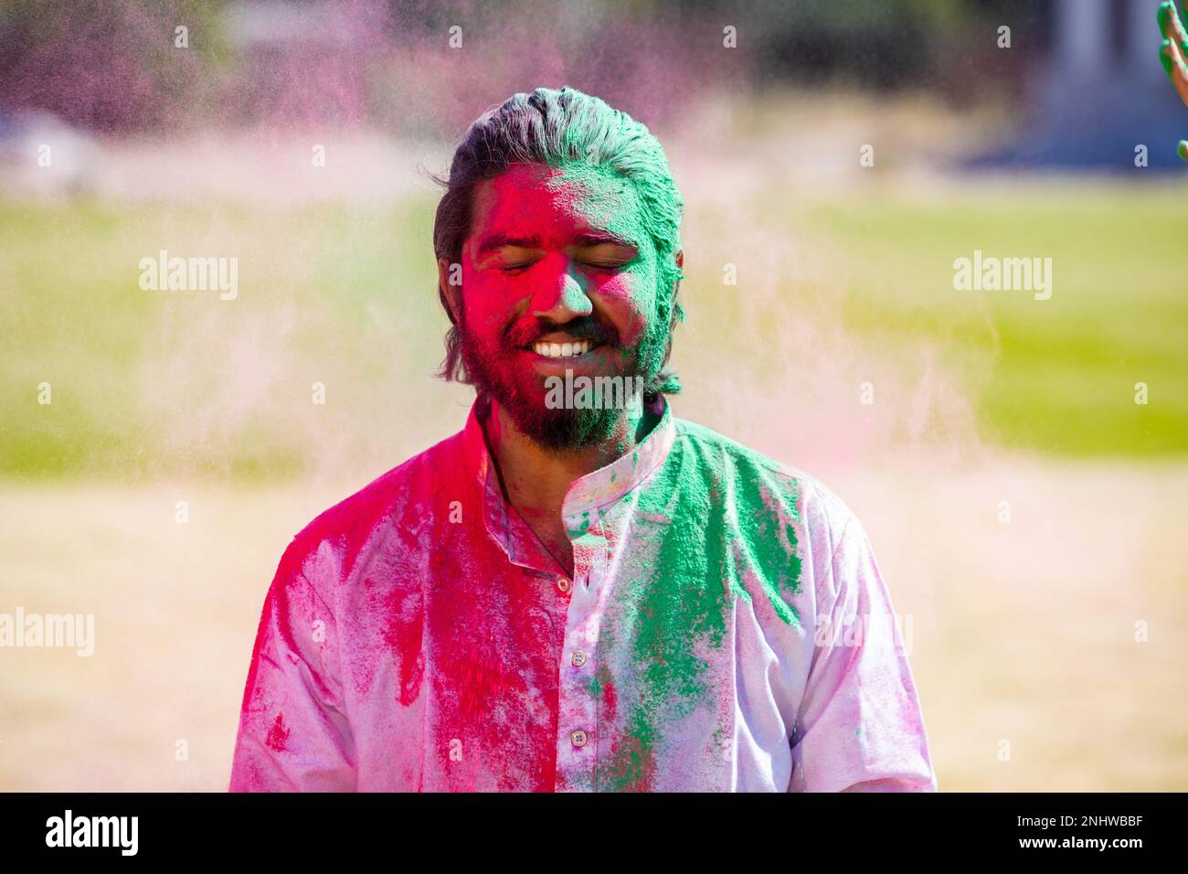 Portrait of happy Indian man wearing sunglasses and painted face ...