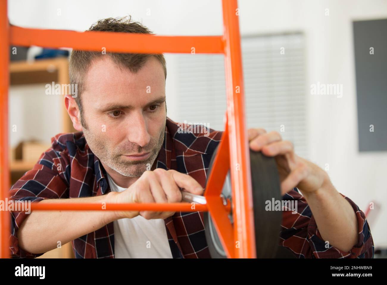 technician fixing trolley wheel Stock Photo - Alamy