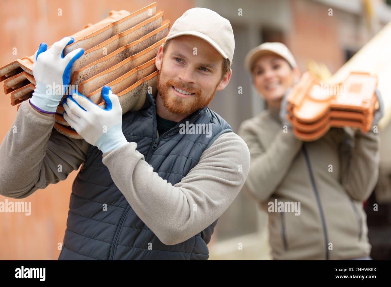 bricklayer industrial workers carrying bricks at construction site ...