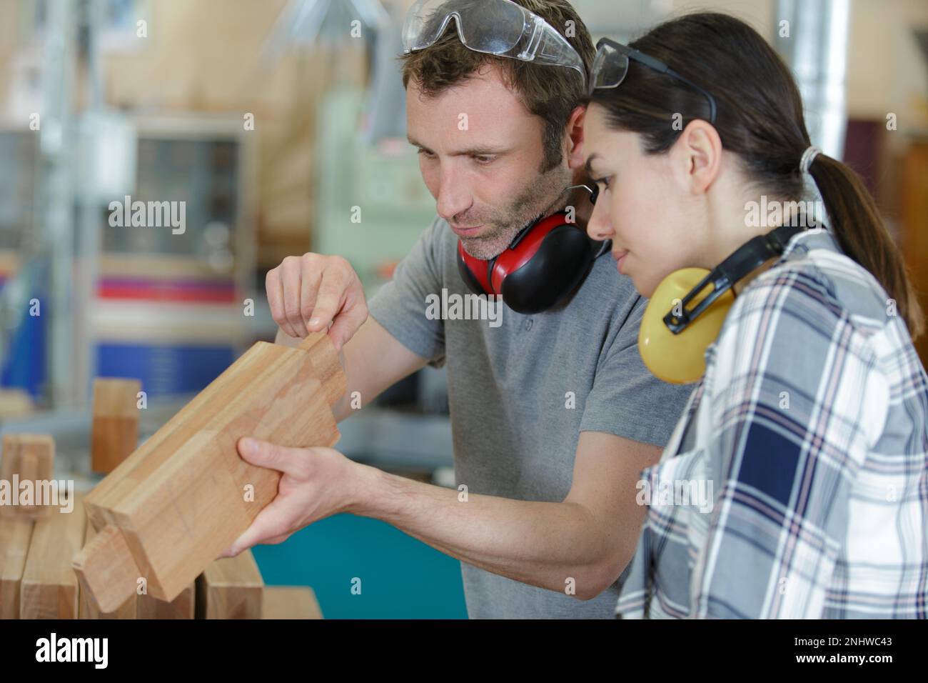 carpenter teaching apprentice how to cut wood Stock Photo - Alamy