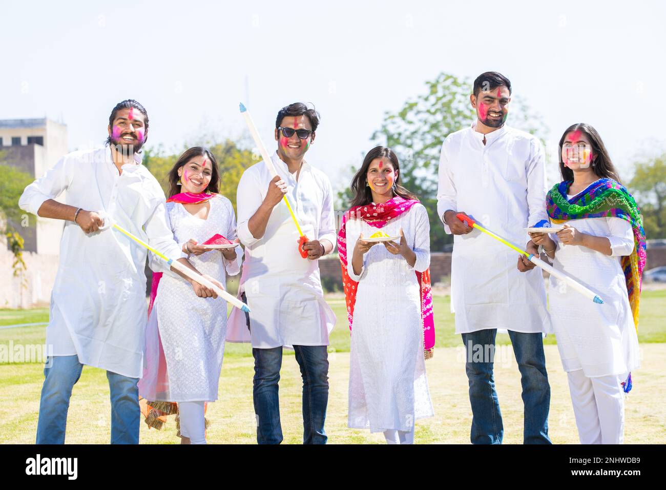 Group of happy young Indian people celebrating holi festival at park ...