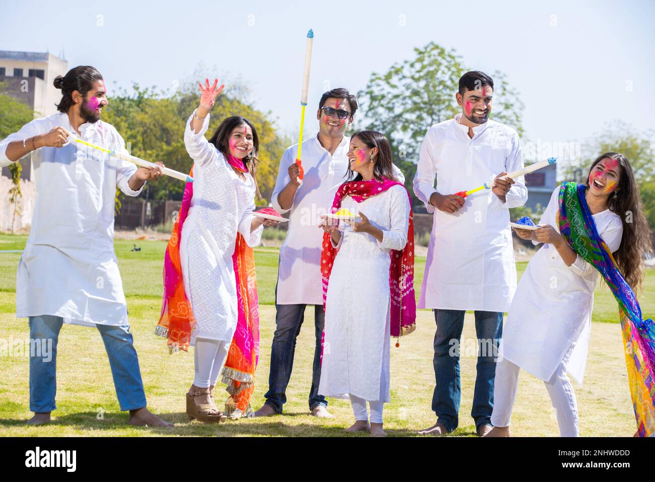 Group of happy young Indian people celebrating holi festival at park ...
