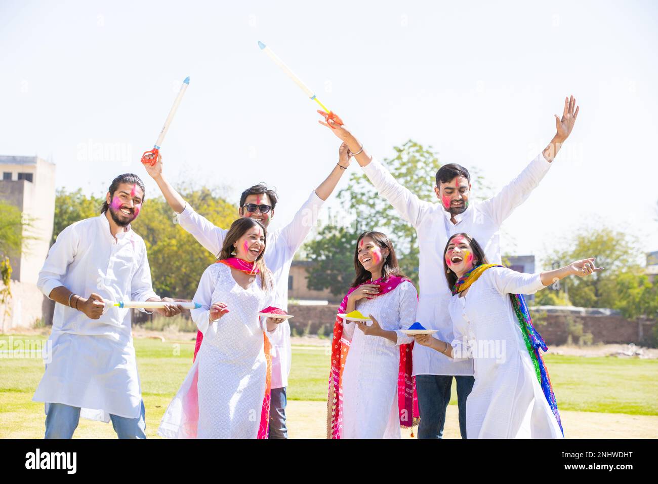 Group of happy young Indian people celebrating holi festival at park ...
