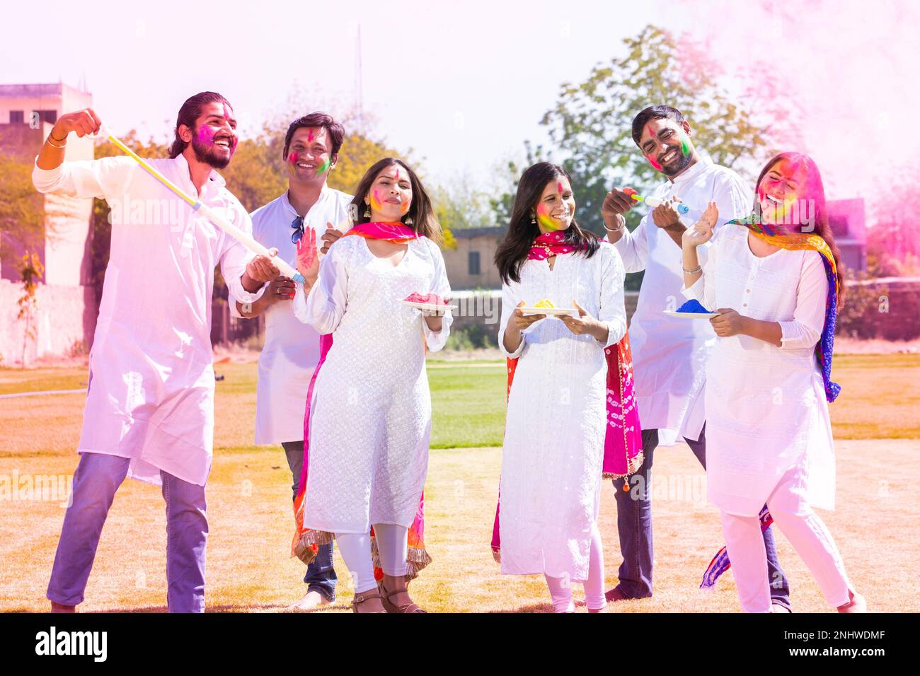 Group of happy young Indian people celebrating holi festival at park ...
