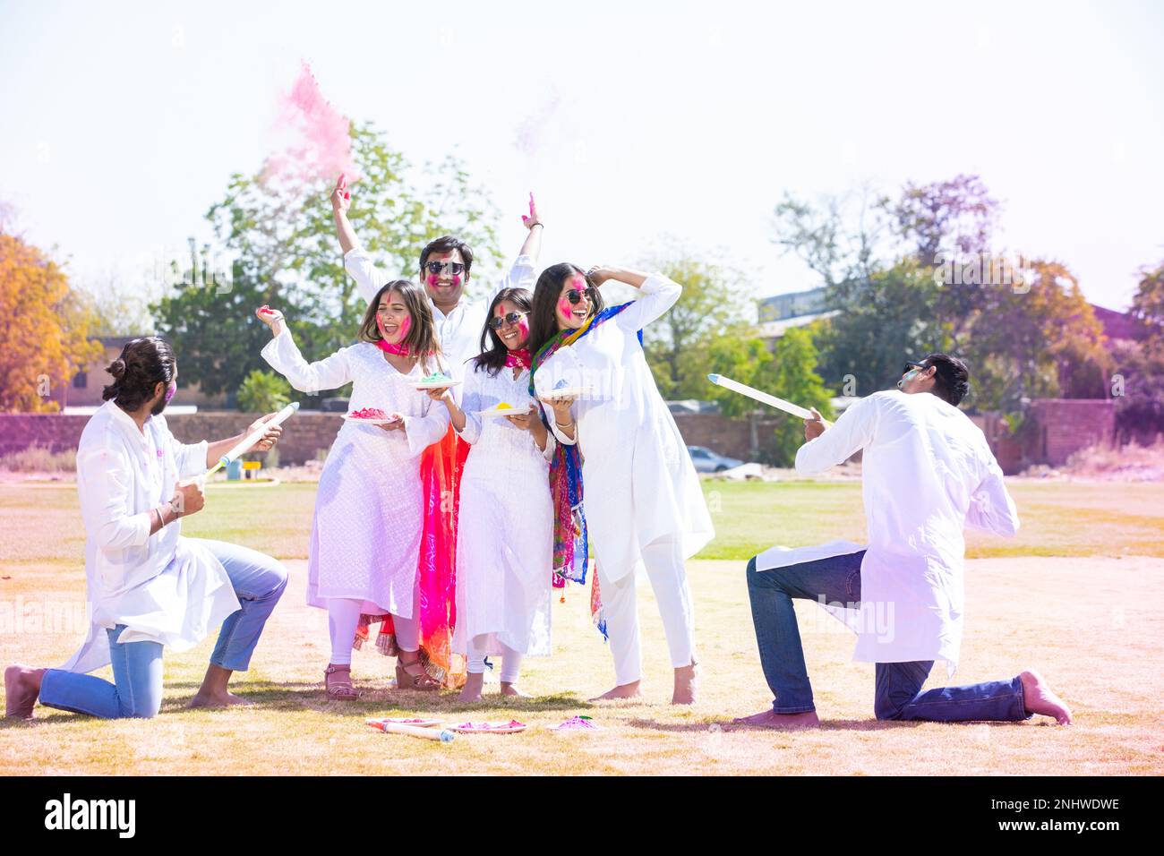 Group of happy young Indian people celebrating holi festival at park ...