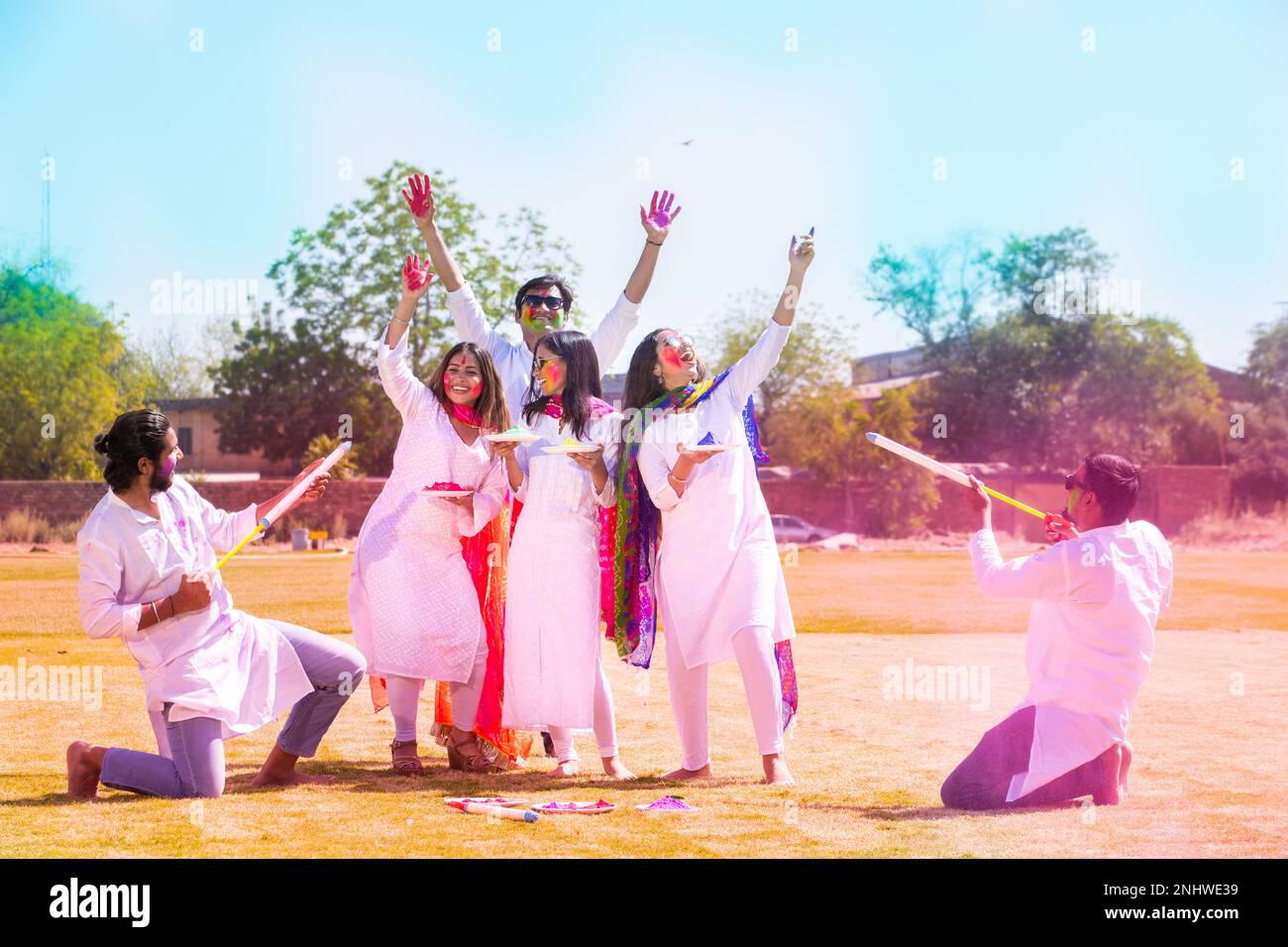 Group of happy young Indian people celebrating holi festival at park ...