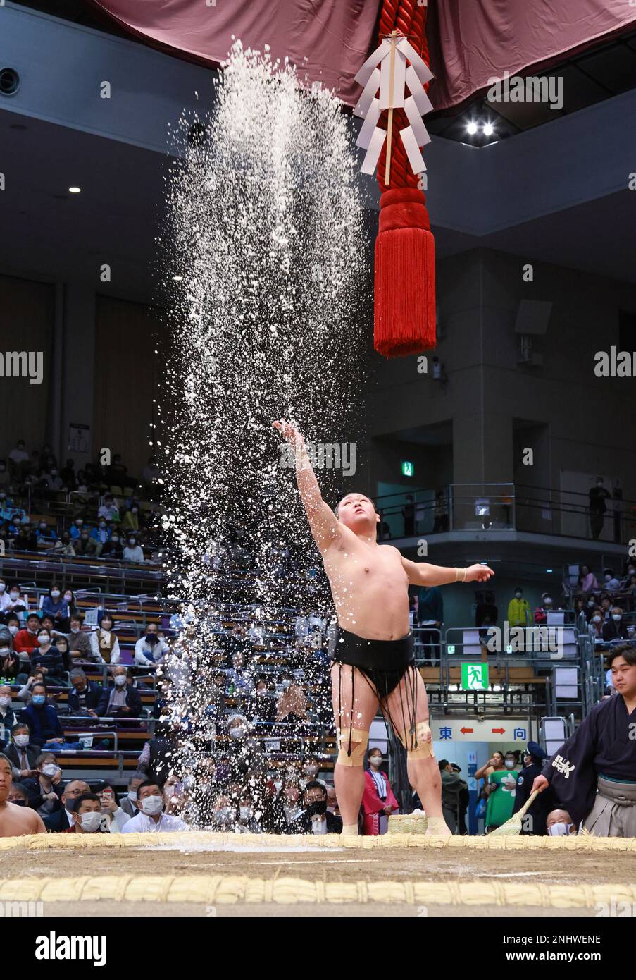 A sumo wrestler Terutsuyoshi throws salt into the ring during Fukuoka ...