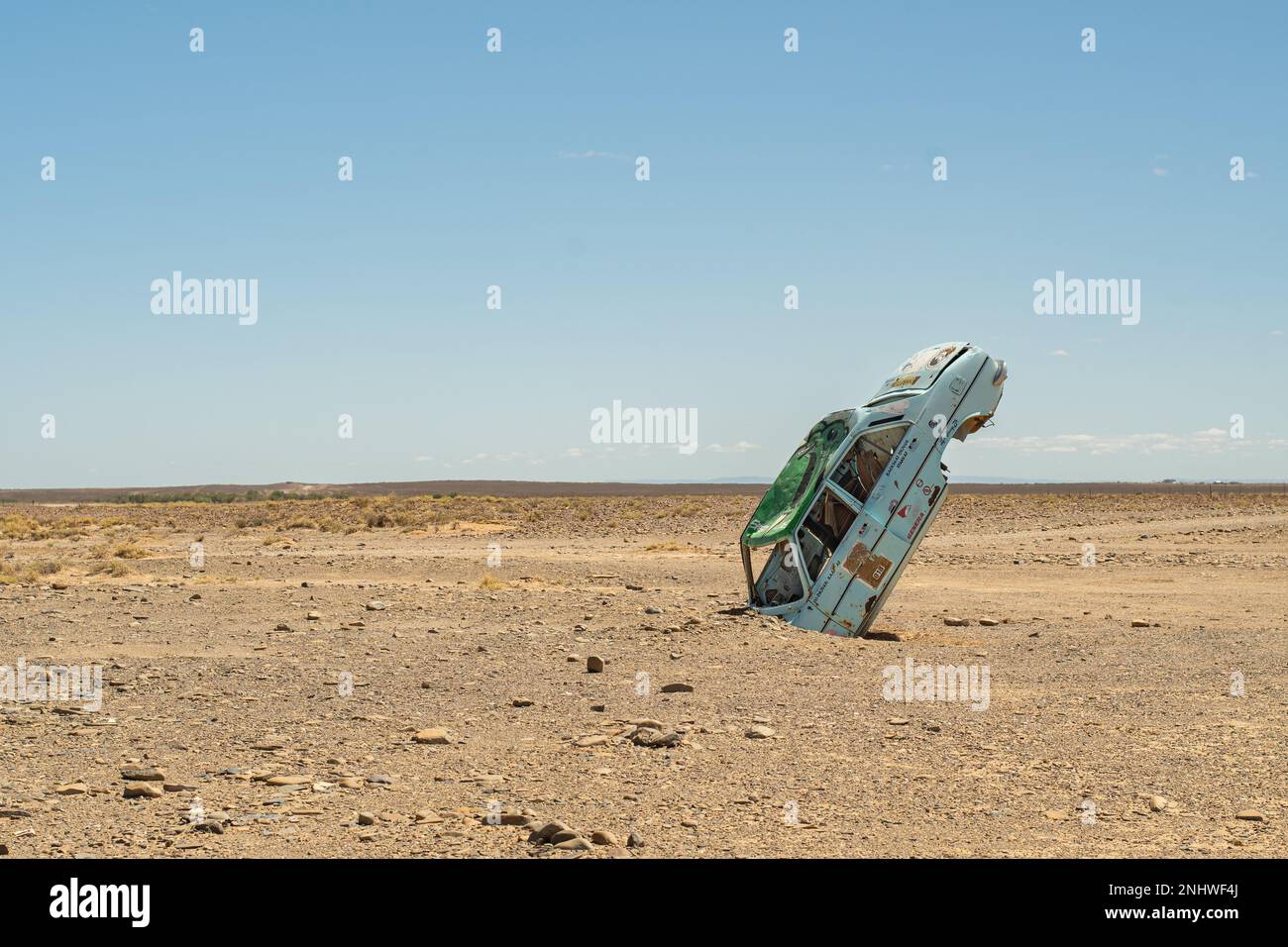 Wrecked car buried in the sand Stock Photo - Alamy