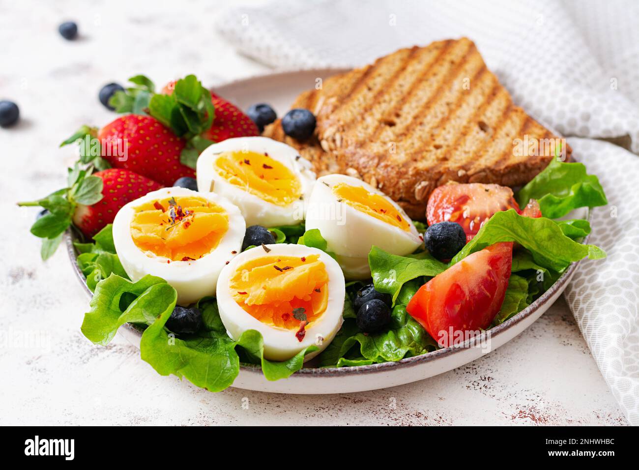 Healthy breakfast. Toast with strawberry and egg. Healthy balanced food ...