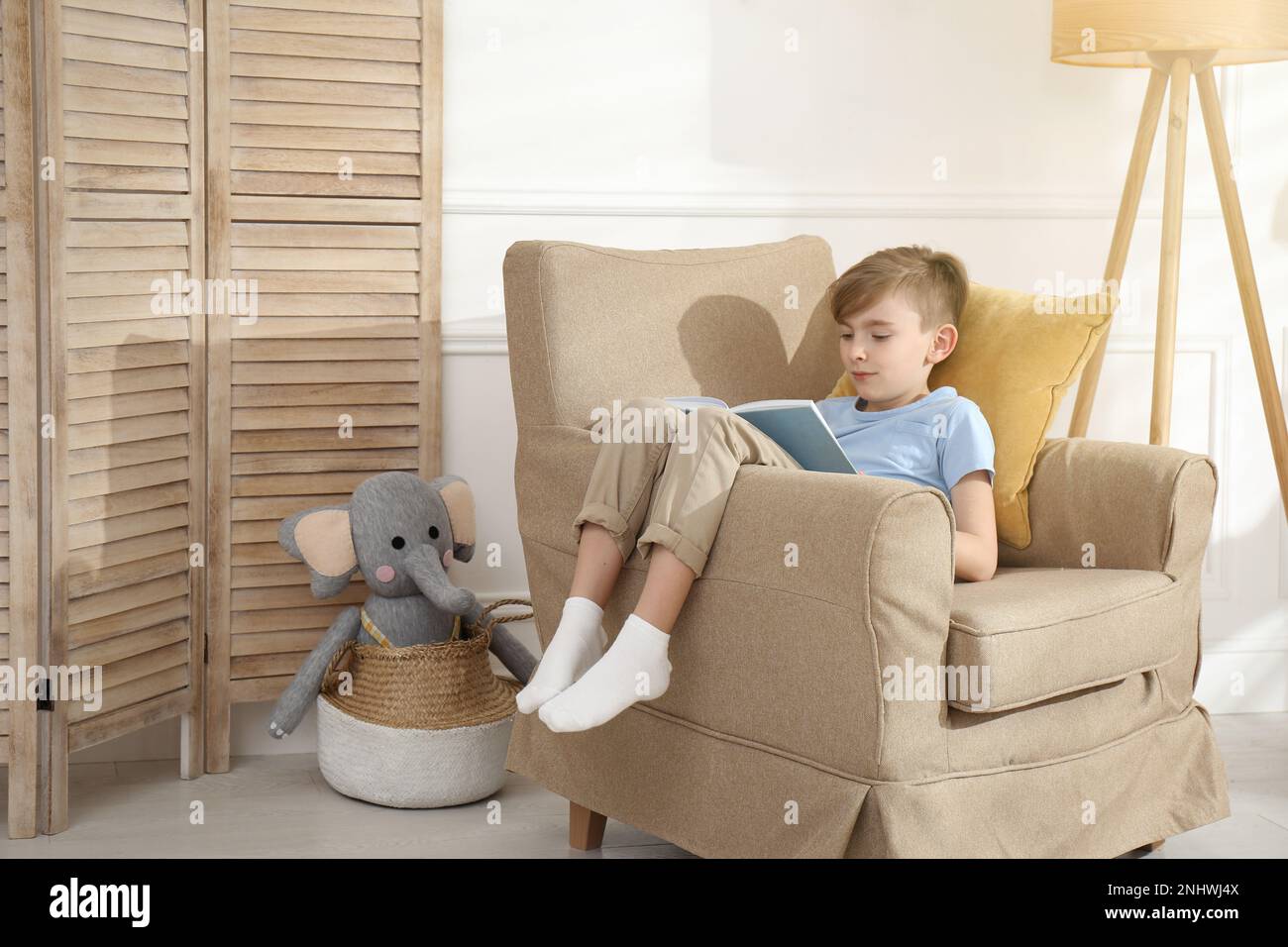 Little boy reading in armchair hi-res stock photography and images - Alamy