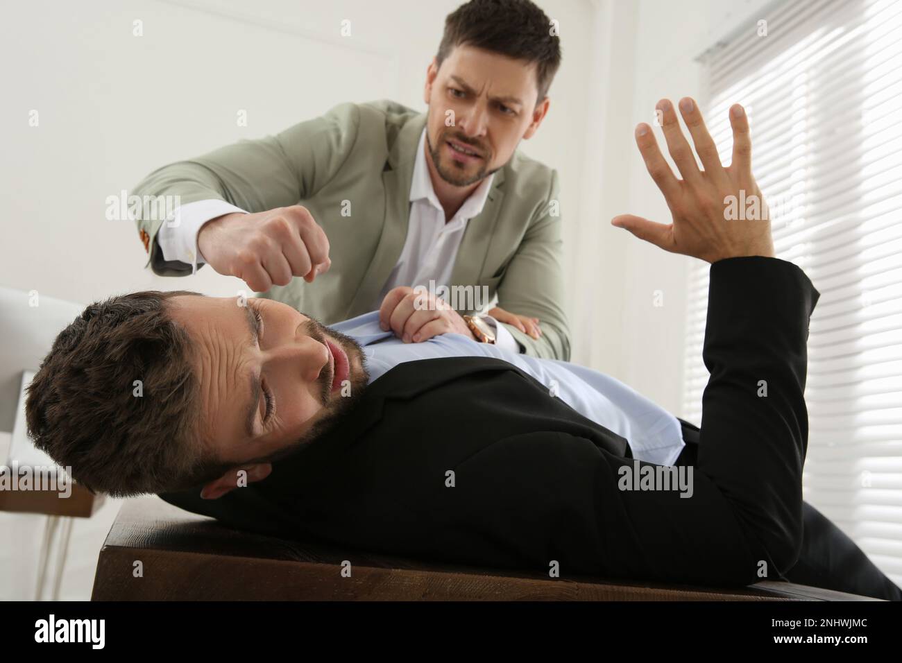 Emotional colleagues fighting in office. Workplace conflict Stock Photo ...