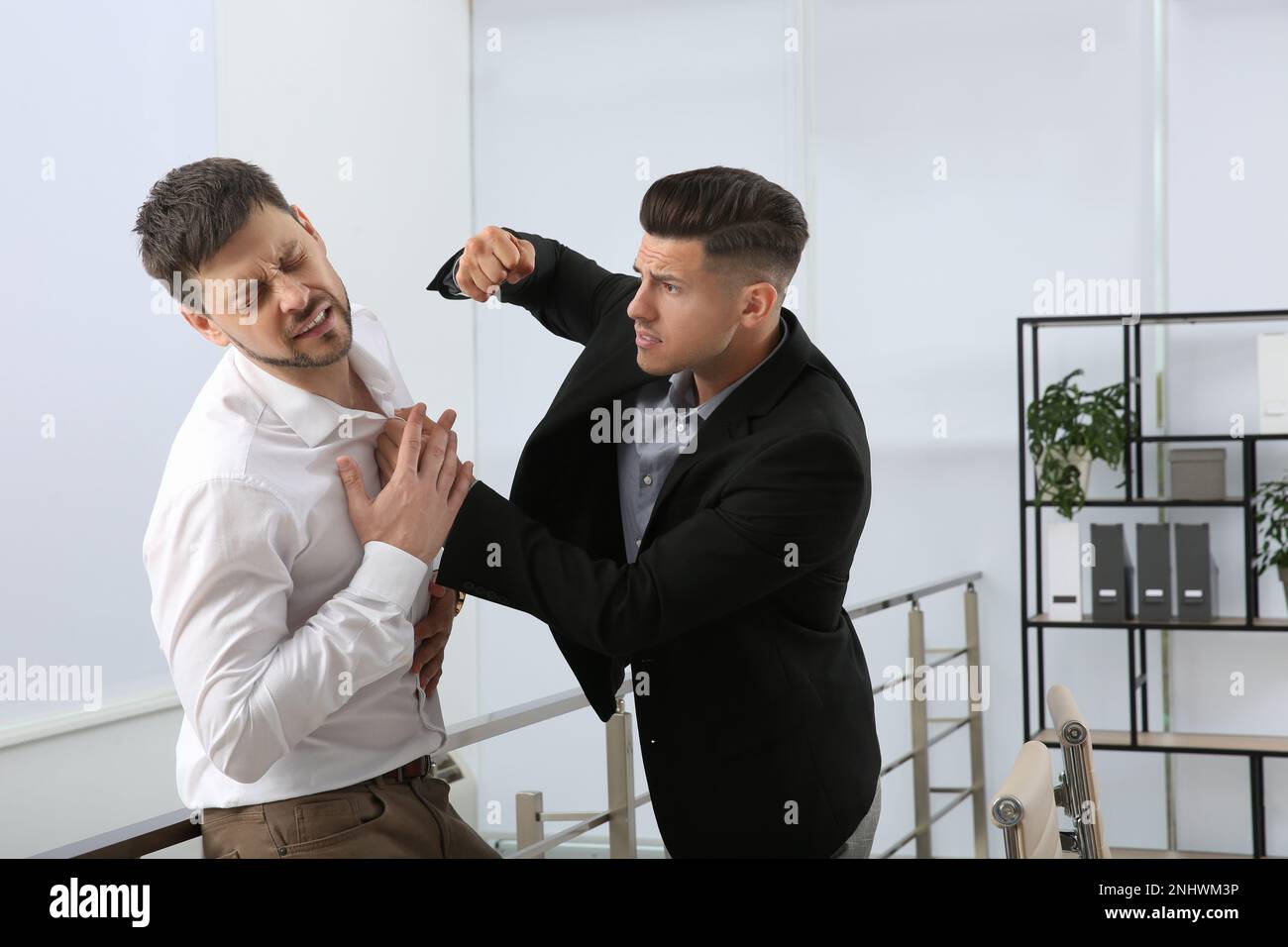 Emotional colleagues fighting in office. Workplace conflict Stock Photo ...