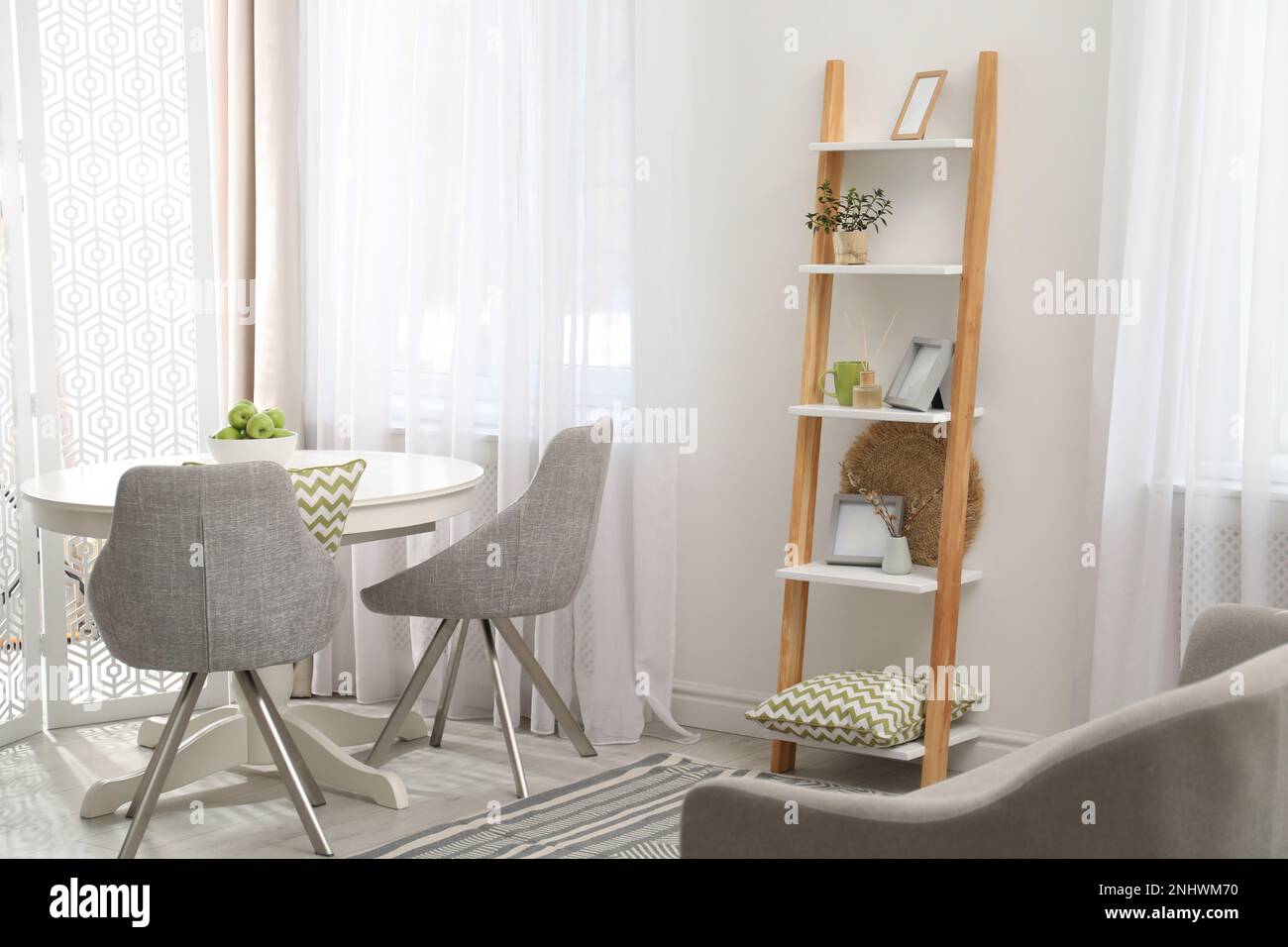Stylish living room interior with wooden ladder near white wall Stock ...