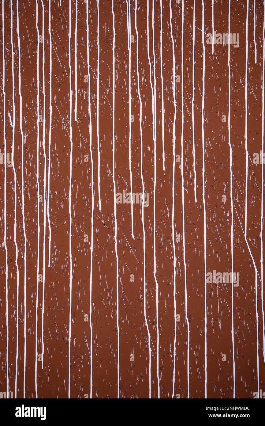 Detail of red wall damaged by vandalism and crime Stock Photo - Alamy